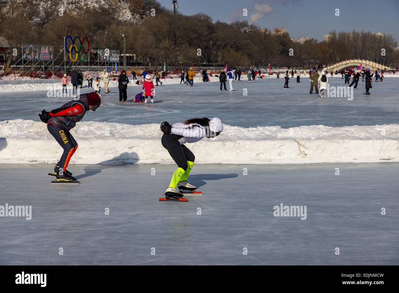 Skating enthusiasts enjoy the public ice rink at a park in Jilin City ...