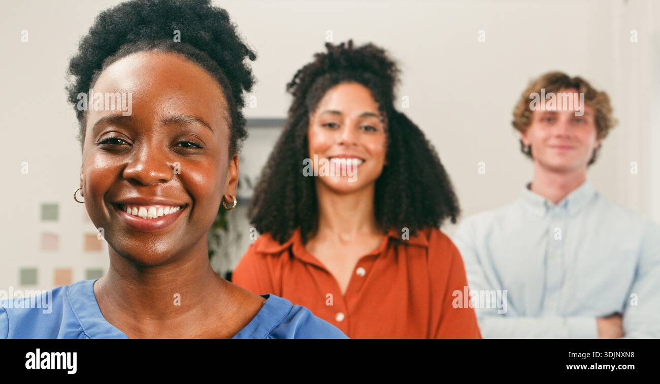 Three Friendly Colleagues in Office Smile While Working on Tech Project ...