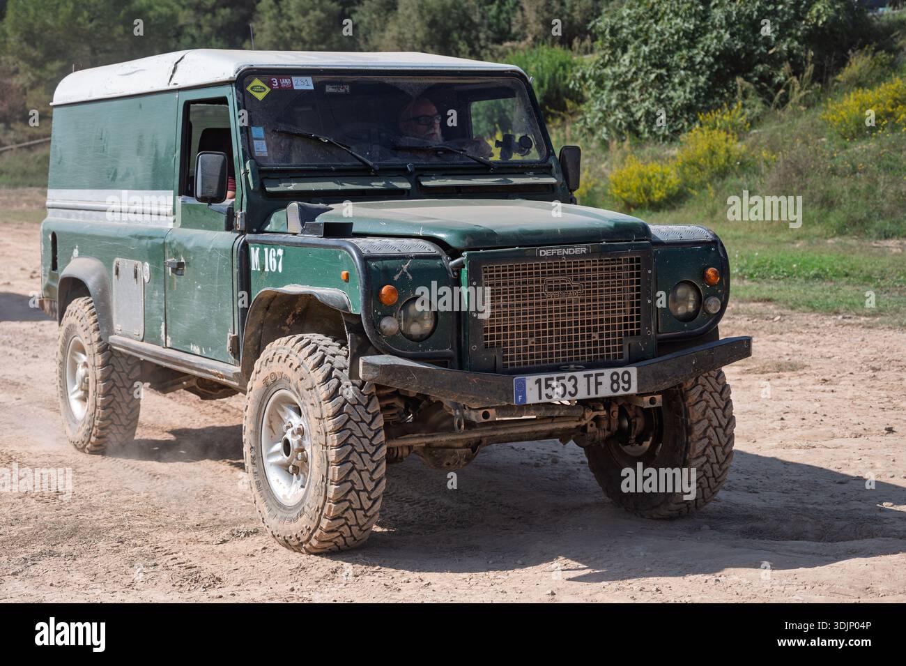 Front view of a heavily modified green Land Rover Defender long ...