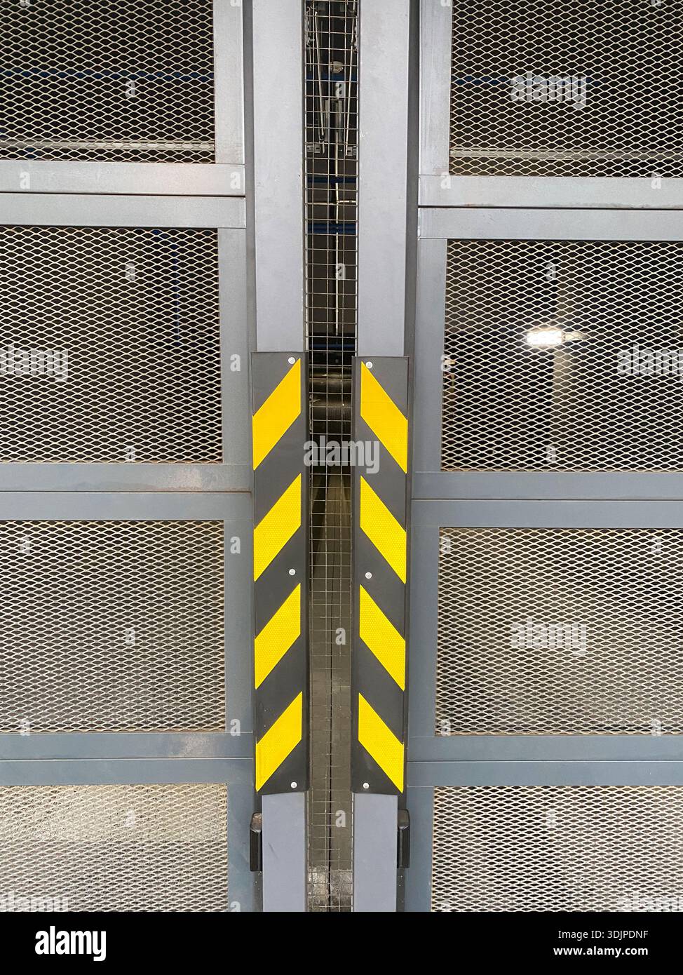Metal gate with mesh design showcases striking yellow and black warning ...