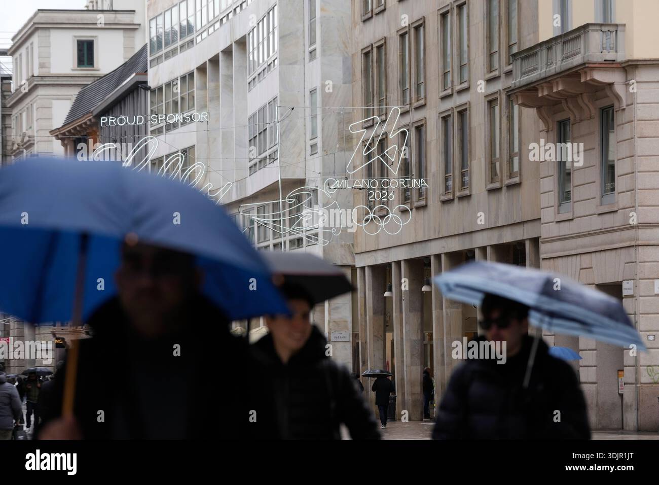 People walk in the rain, in Milan, Italy, Wednesday, Jan. 28, 2026. (AP ...