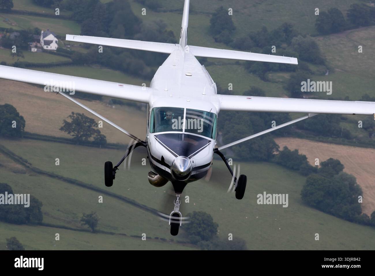 Head-on air-to-air view of a Cessna 208B Grand Caravan captured during ...