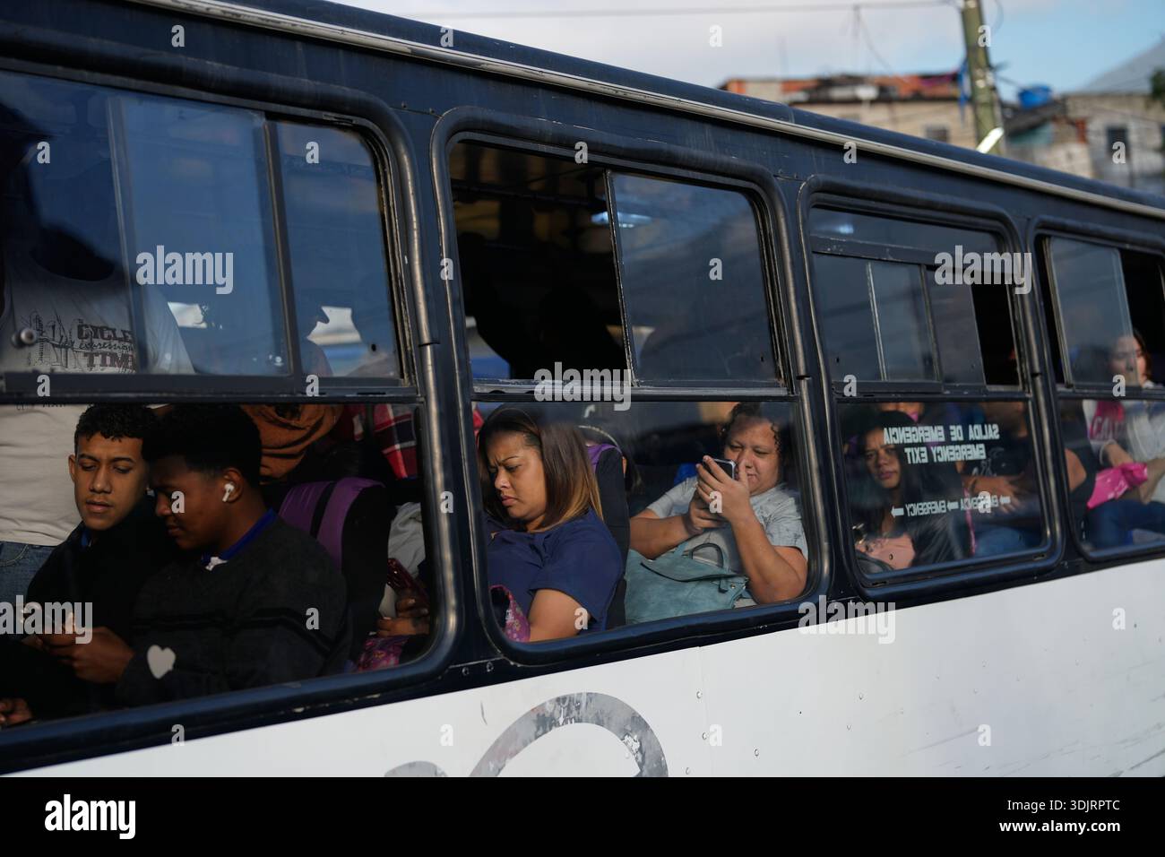 Commuters ride on a bus during rush hour in Caracas, Venezuela ...
