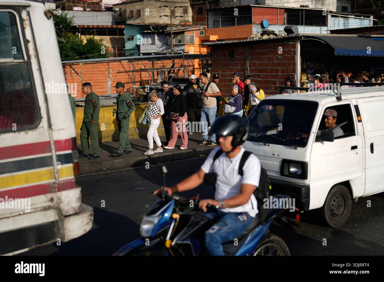 People line up for a bus during rush hour in Caracas, Venezuela ...