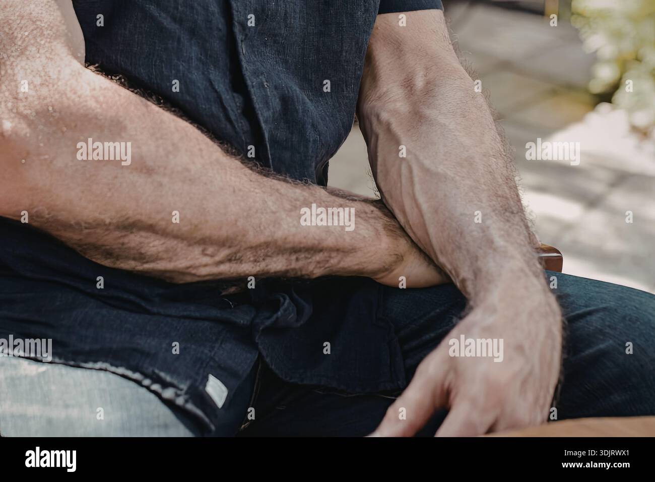 A close-up image of a man's arm and leg, showcasing prominent veins ...