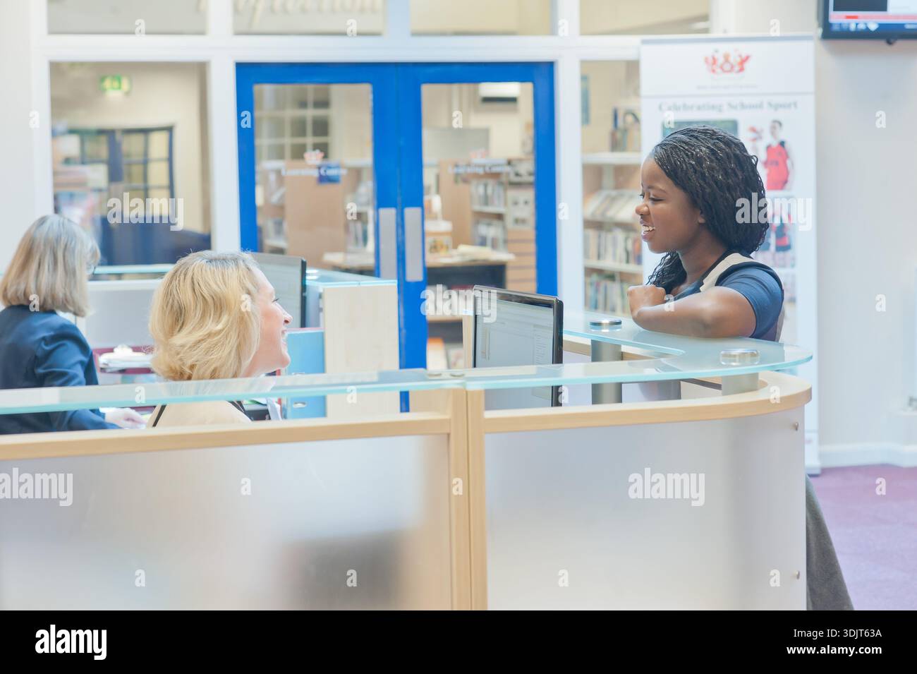 A black female comprehensive school sixth former in a school reception ...