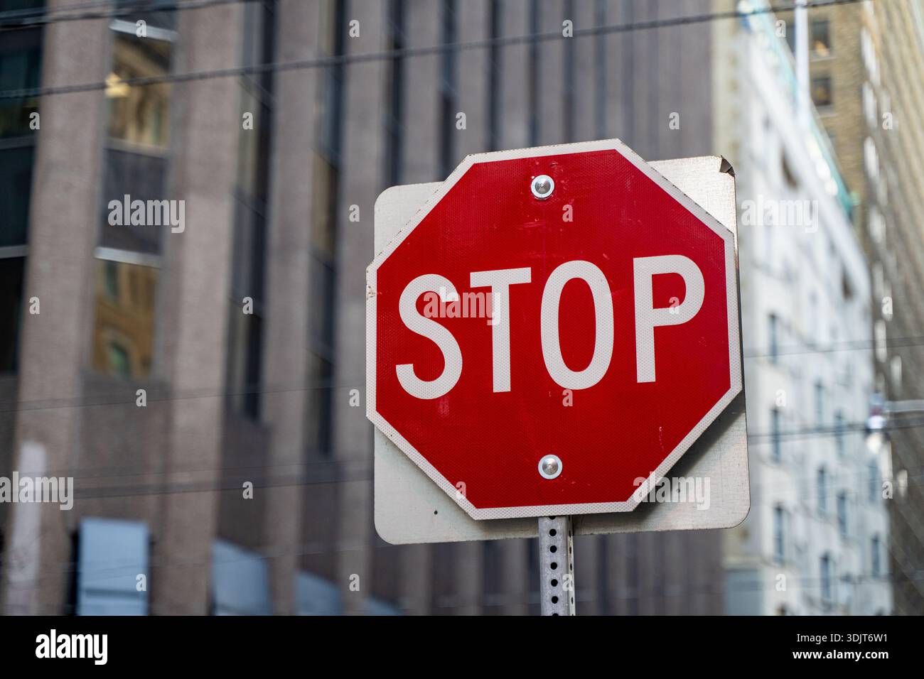 Stop sign between skyscrapers hi-res stock photography and images - Alamy