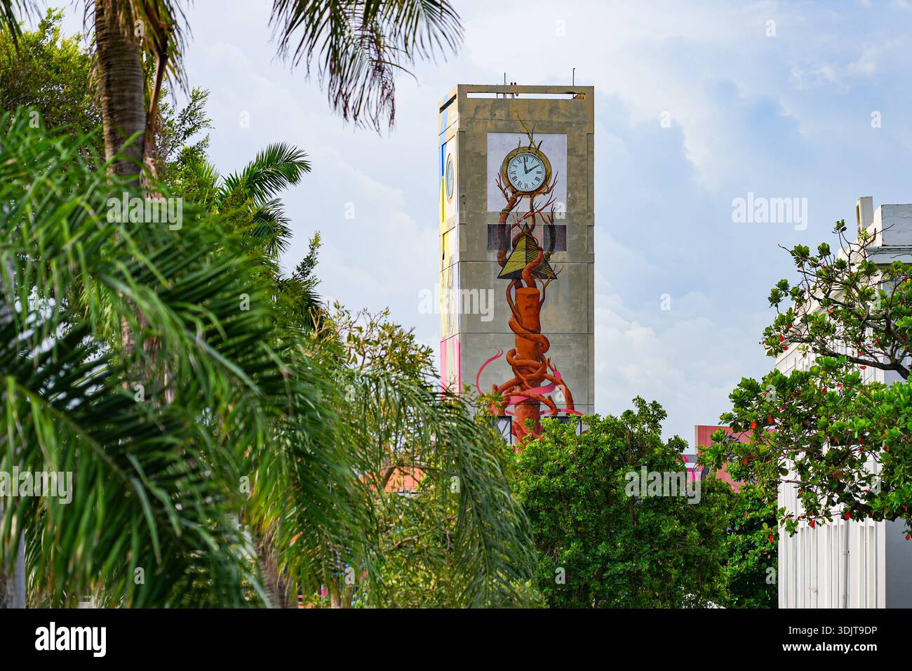 Colorful clock tower mural surrounded by tropical palm trees in San ...