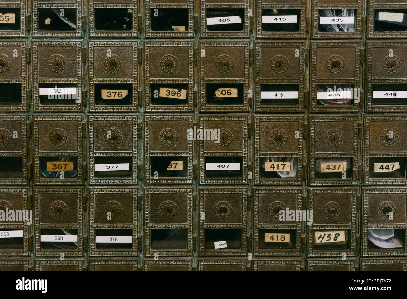 Compartments in a mailbox wall display various numbers in a building ...