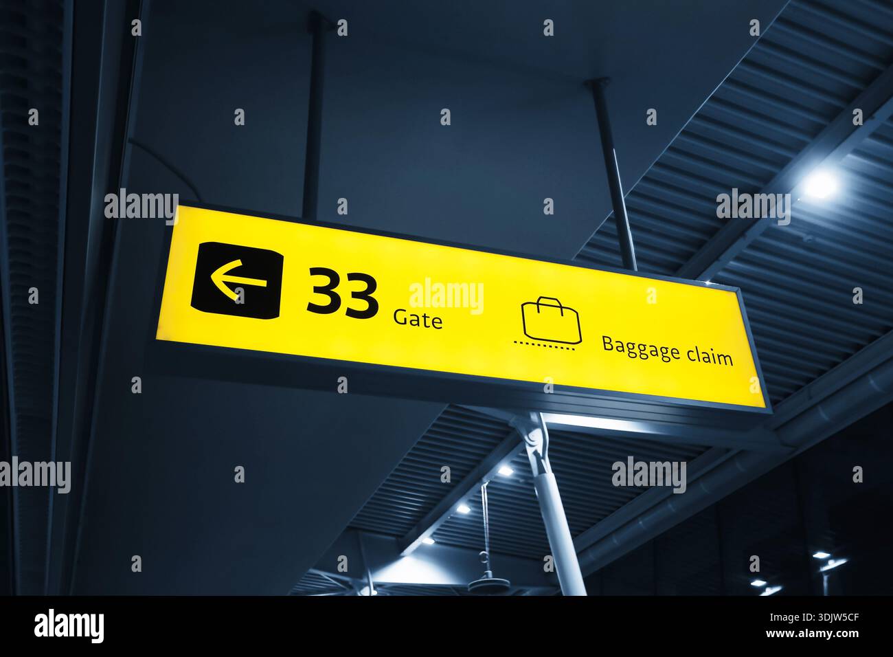 Airport directional sign showing gate number and baggage claim ...