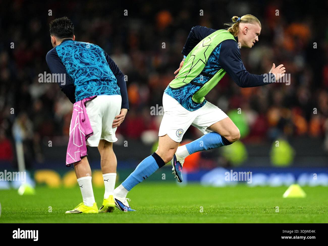 Manchester City's Erling Haaland (right) warming up prior to kick-off ...