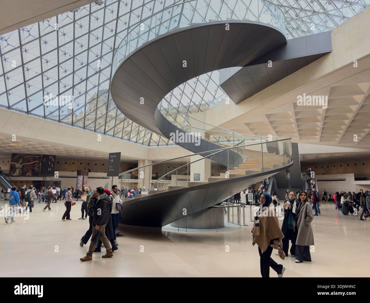 Spiral staircase below the glass pyramid at the Louvre Museum - Paris ...