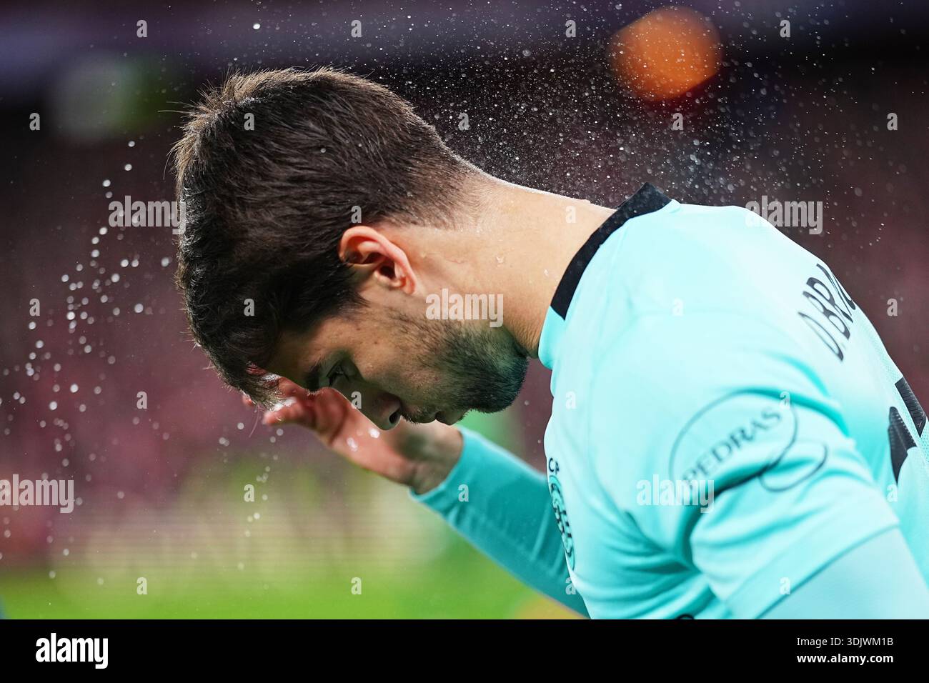 Sporting's Daniel Braganca sprays water on his face during the ...