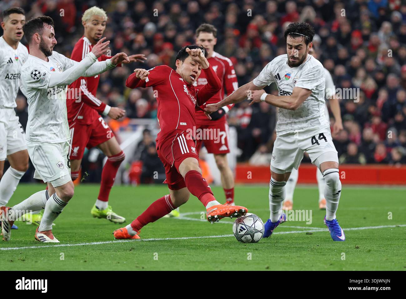 Liverpool's Wataru Endo, centre, challenges for the ball with Qarabag's ...