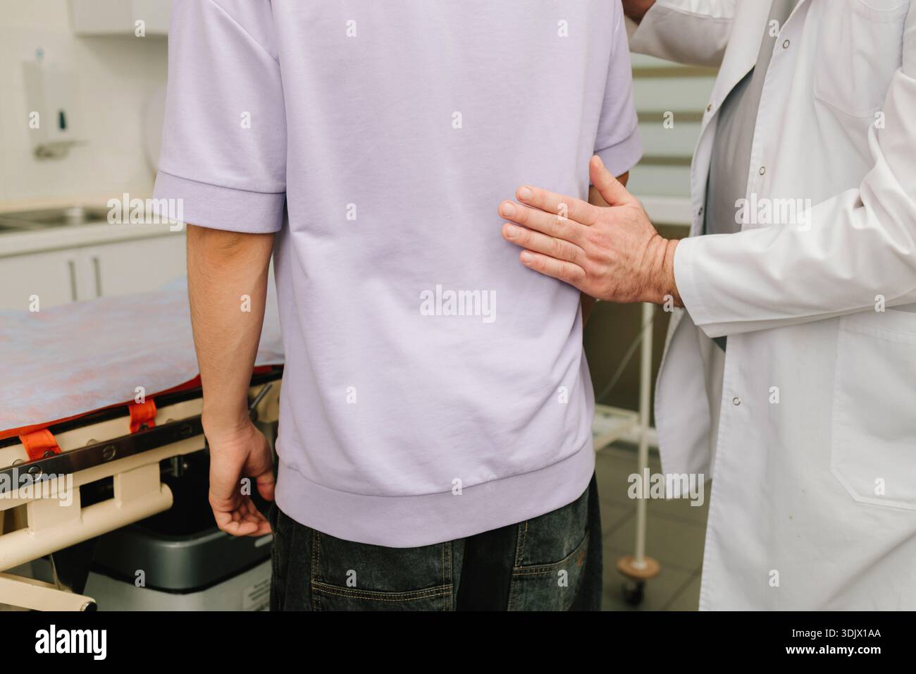 Urologist performs renal percussion assess hi-res stock photography and ...
