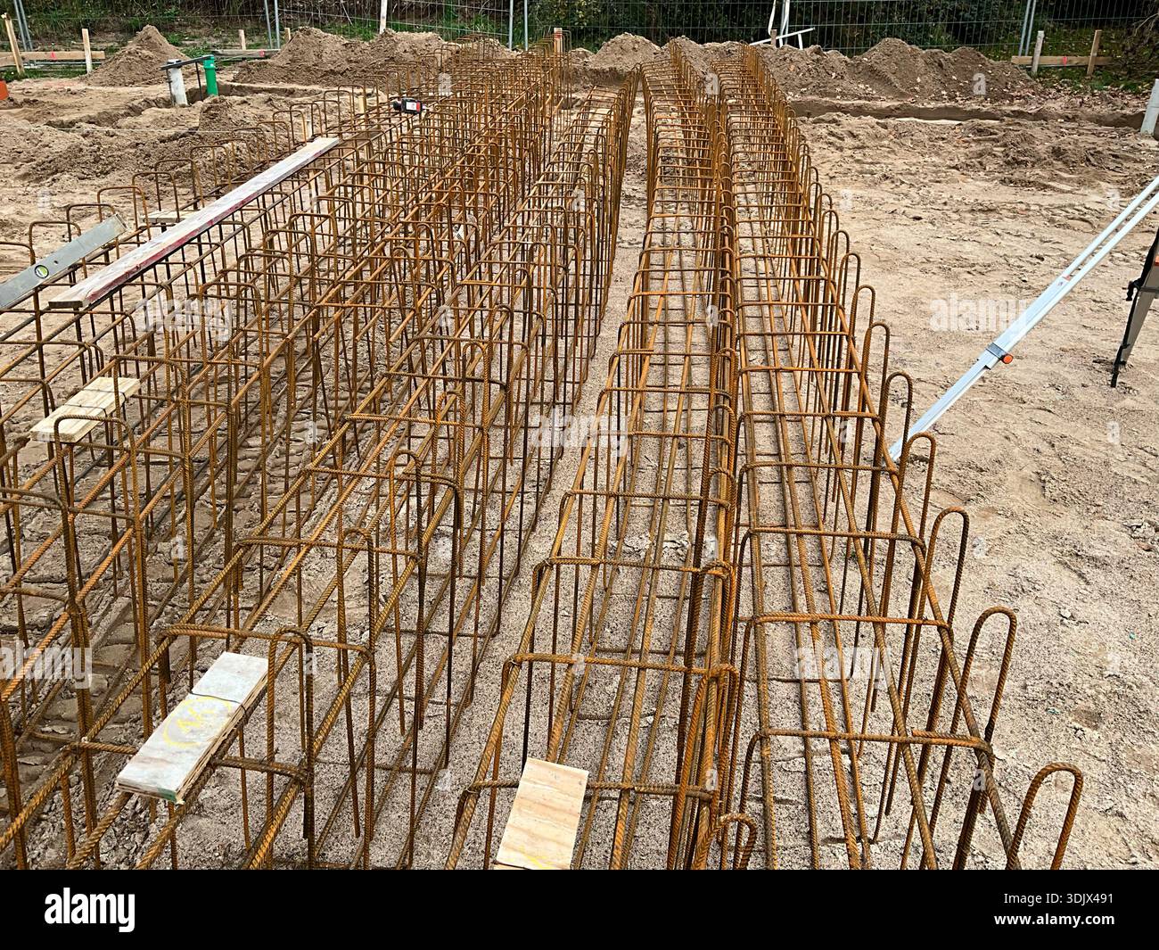 Steel rebar cages prepared for concrete strip foundations at a ...