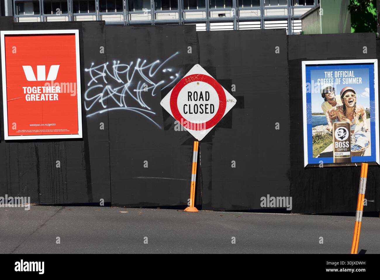 Road closed sign mounted on a temporary construction barrier with ...