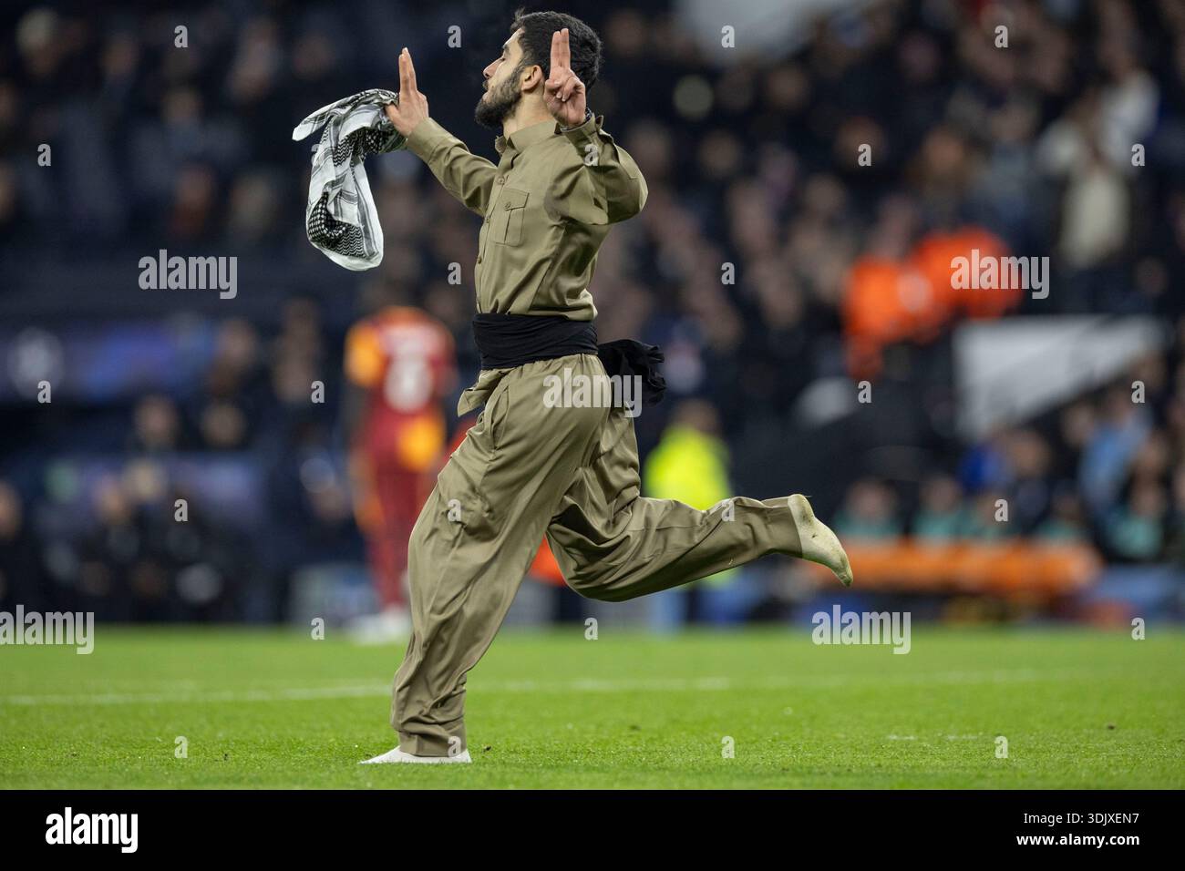 Palestinian fan runs into the pitch during the UEFA Champions League ...