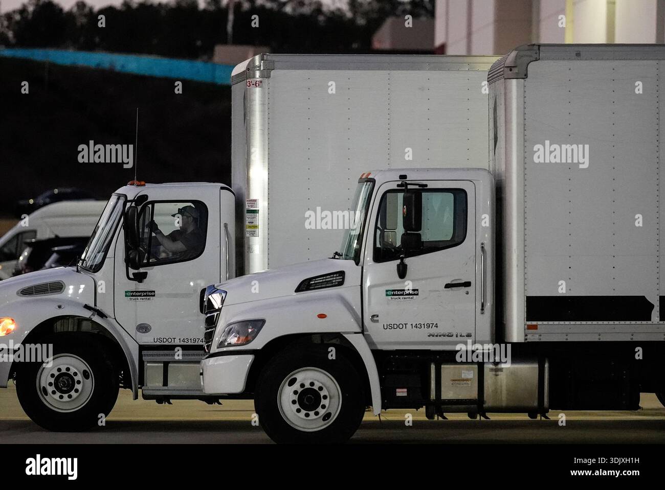 A third truck backs in to the dock at the Fulton County Elction HUB ...