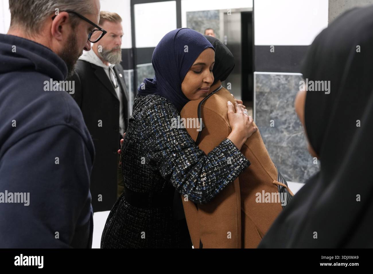 Rep. Ilhan Omar, D-Minn., left, hugs an attendee after a press ...