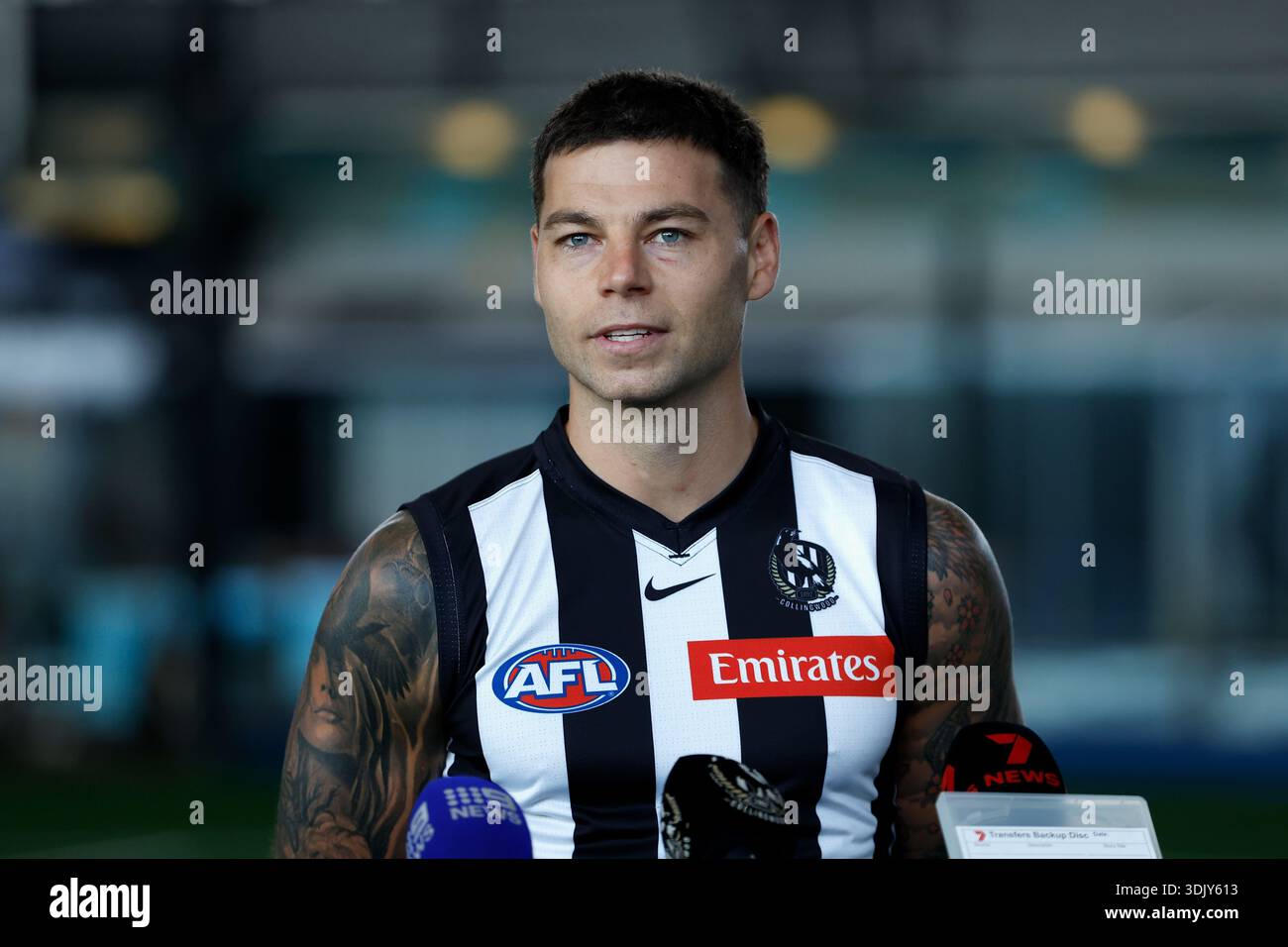 Jamie Elliott speaks to media prior to the Collingwood AFL players pose ...