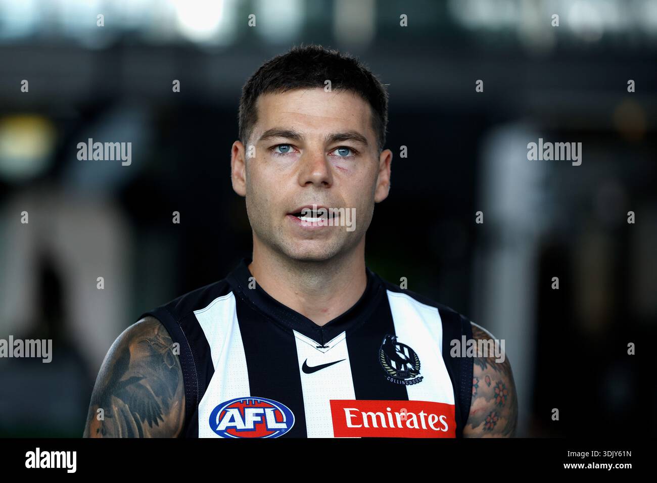 Jamie Elliott speaks to media prior to the Collingwood AFL players pose ...