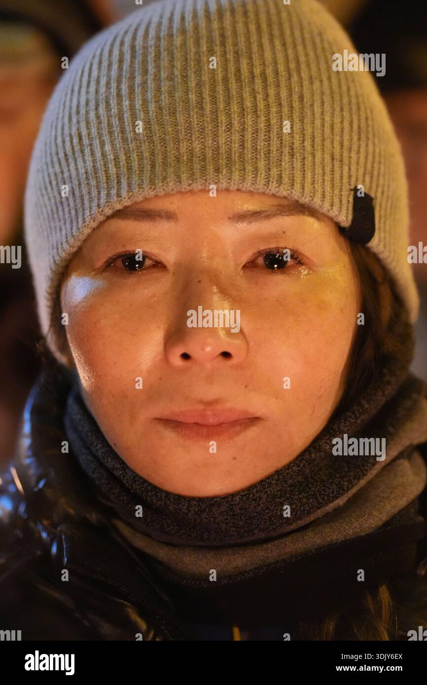 An attendee sheds tears during a vigil where Alex Pretti was shot and ...