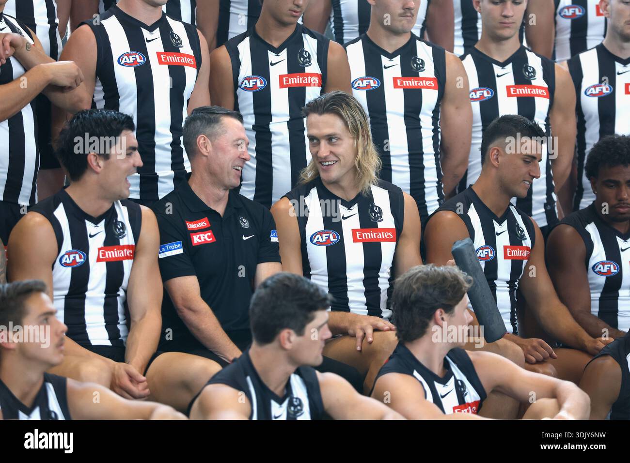 Coach Craig McRae and Collingwood AFL players pose for a team photo at ...