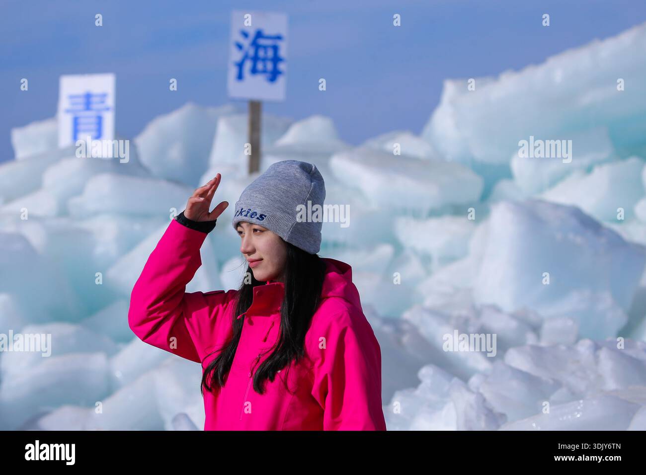 Gonghe,China.28th January 2026. A tourist poses for a photo with "blue ...