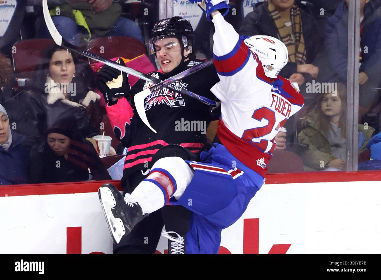 Edmonton Oil Kings LW Jaxon Fuder, rt, collides with Calgary Hitmen RW ...