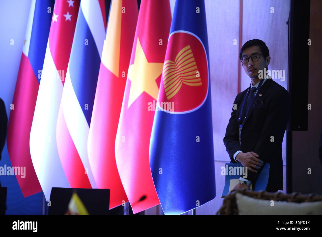 A delegate stands near rows of flags during the Association of ...