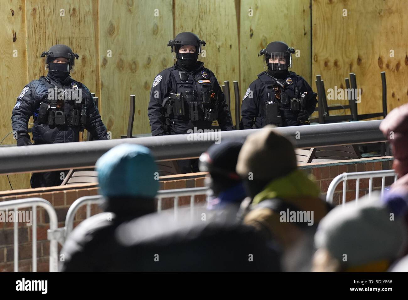 Police stand during a noise demonstration outside the Graduate by ...