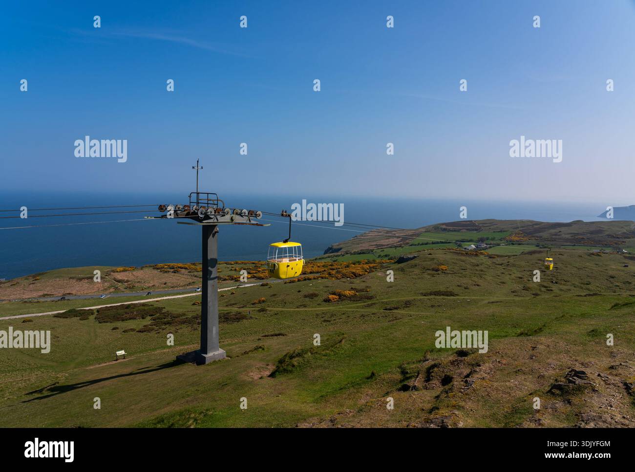 Yellow cable car cabin passing a support pylon on the Great Orme ...