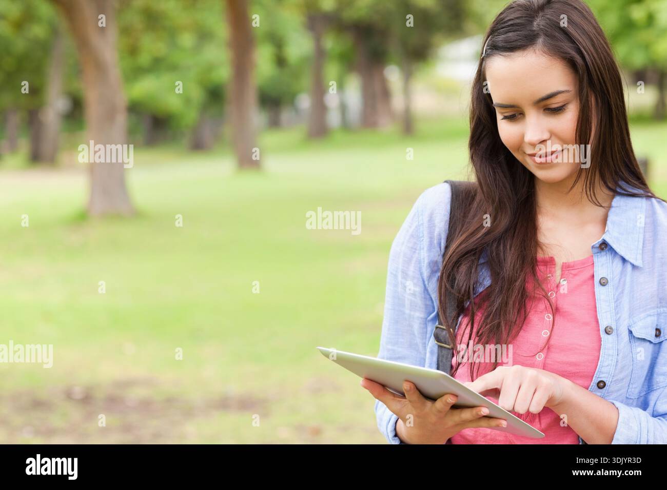 Teenage student tapping tablet screen hi-res stock photography and ...