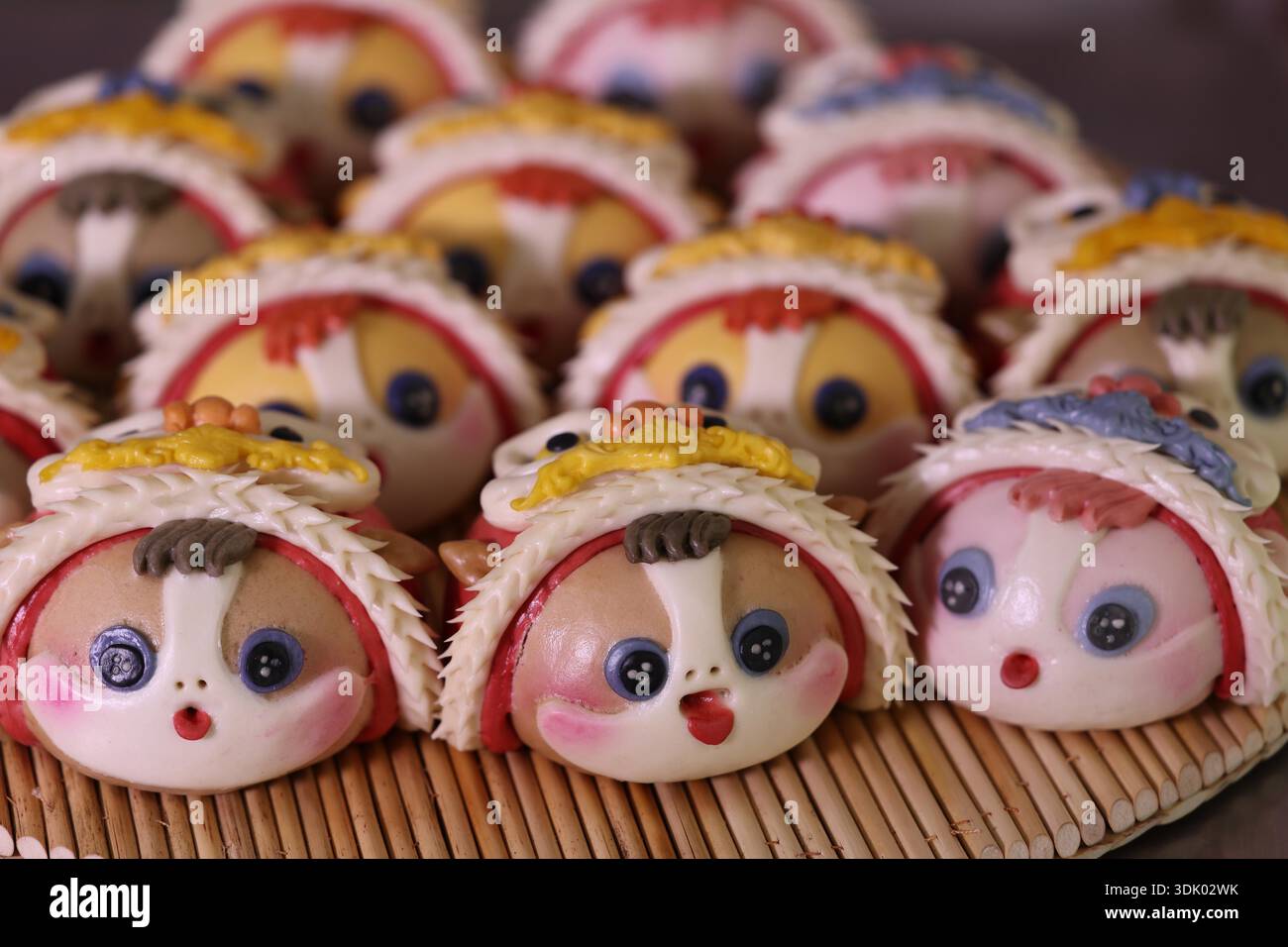 A worker displays freshly steamed traditional flower buns at a heritage ...