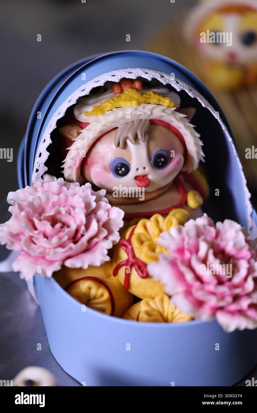 A worker displays freshly steamed traditional flower buns at a heritage ...