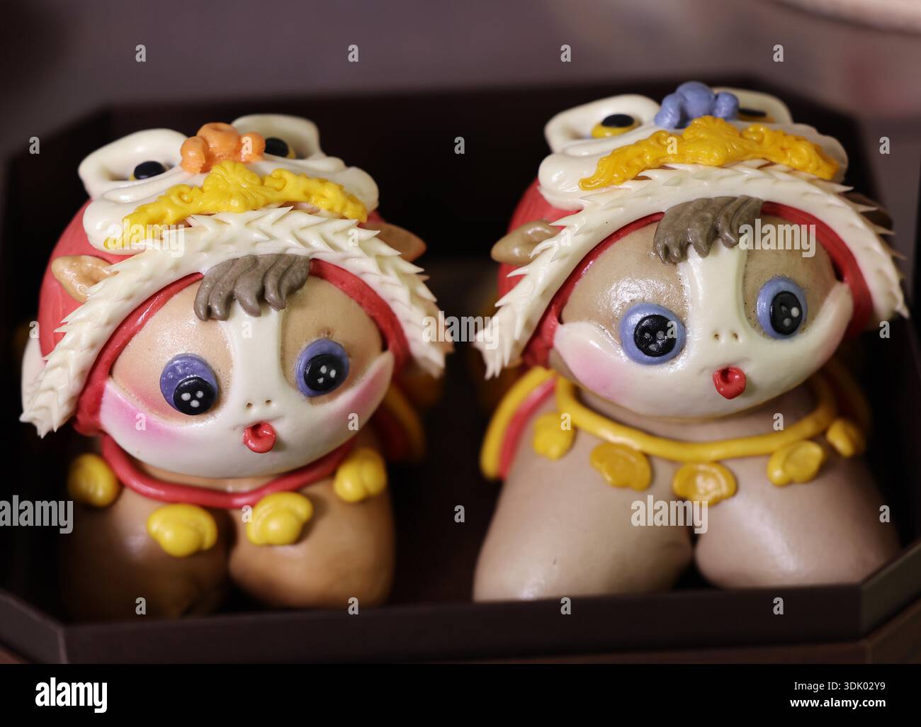 A worker displays freshly steamed traditional flower buns at a heritage ...
