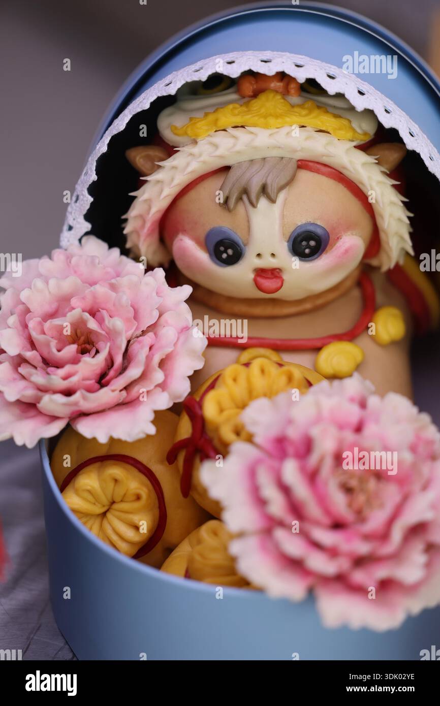 A worker displays freshly steamed traditional flower buns at a heritage ...