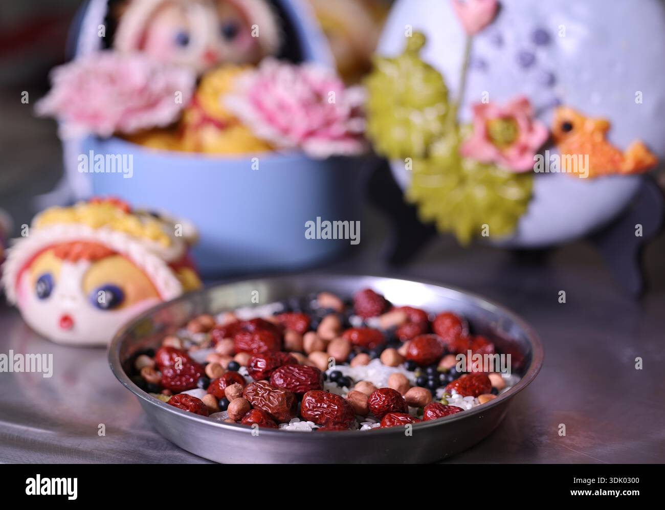 A worker displays freshly steamed traditional flower buns at a heritage ...