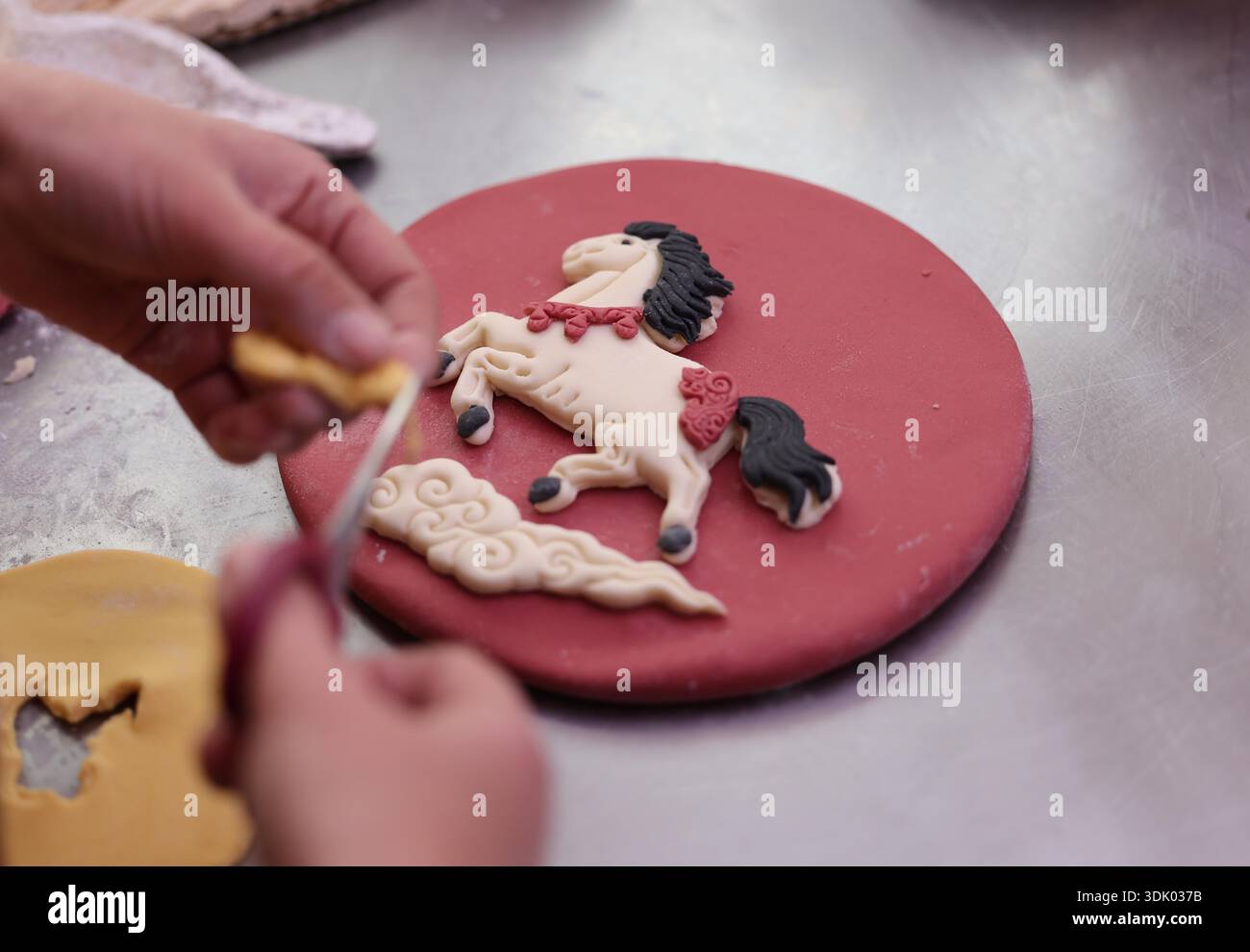 A worker displays freshly steamed traditional flower buns at a heritage ...