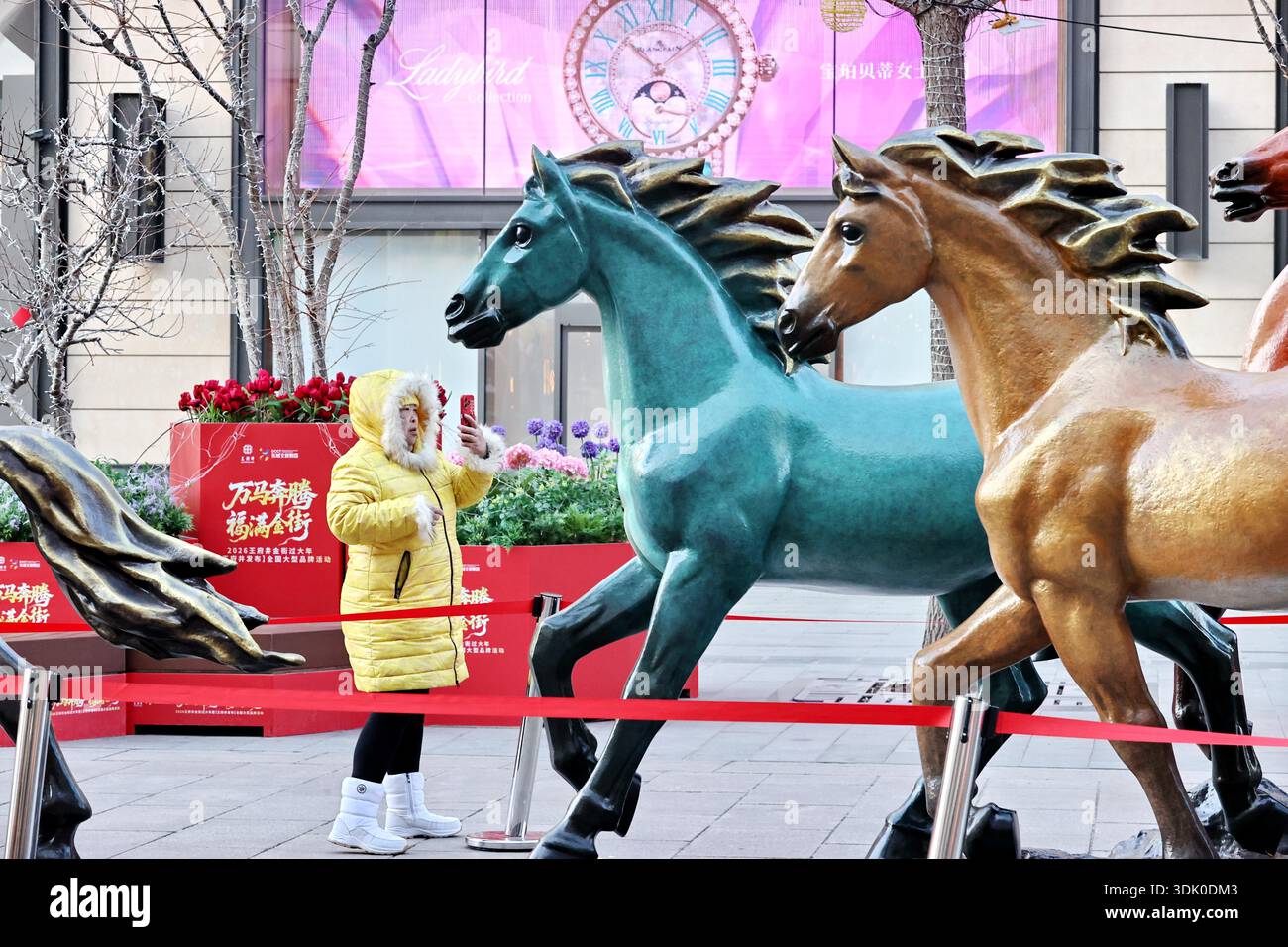 Visitors take photos with the 13-meter-long bronze artwork in ...