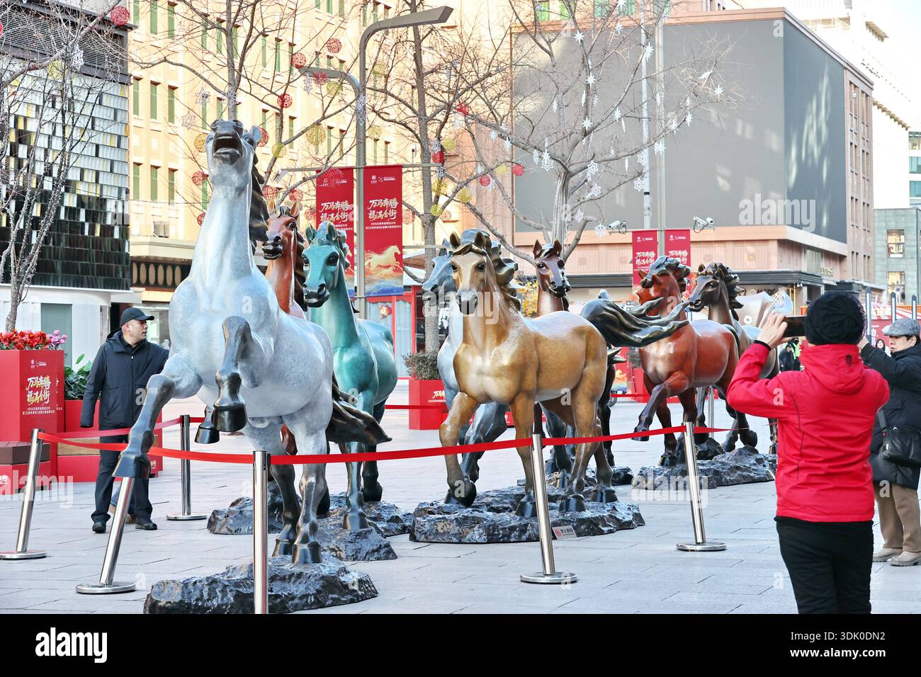 Visitors take photos with the 13-meter-long bronze artwork in ...