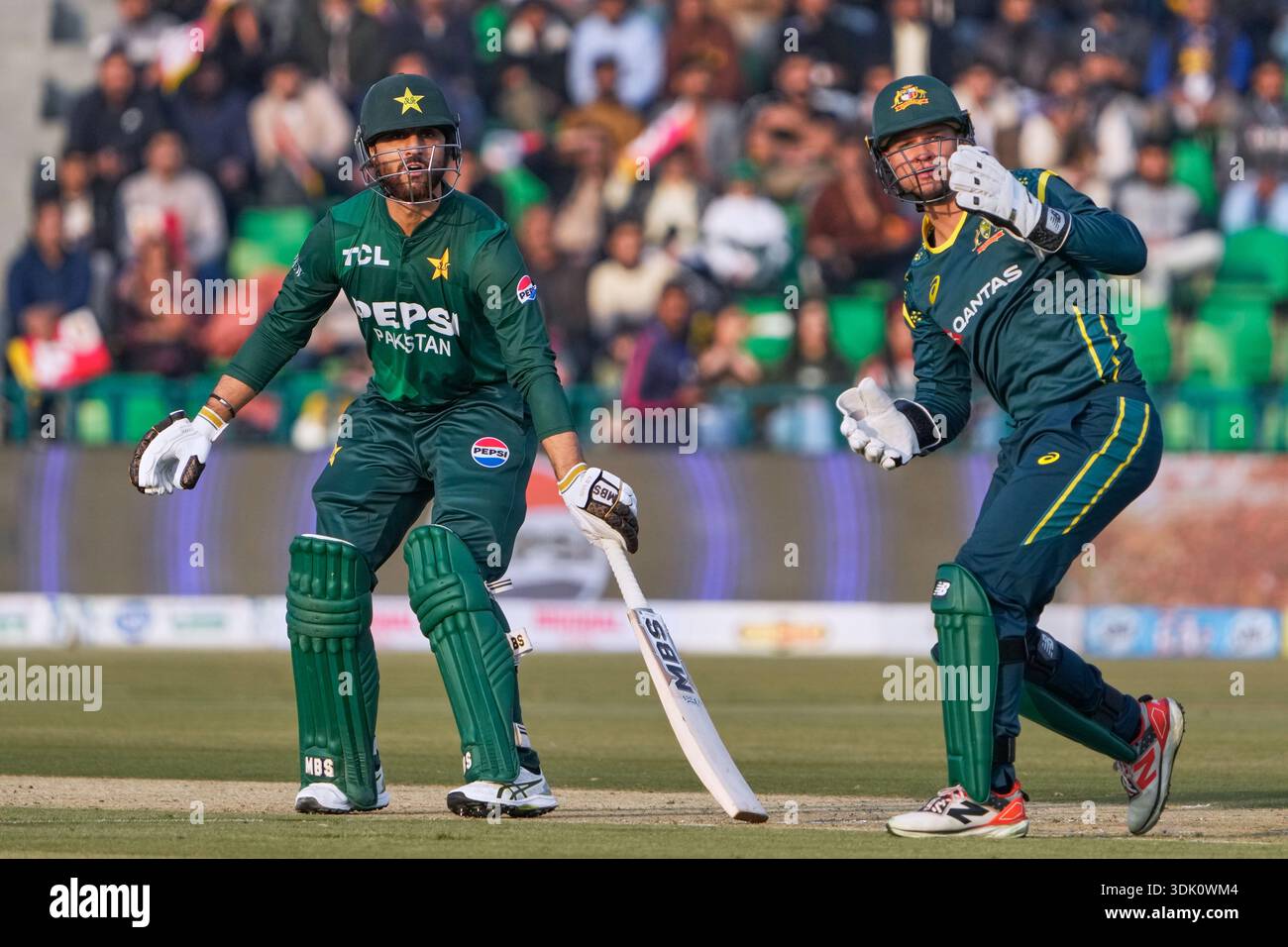 Pakistan's Salman Ali Agha, left, follows the ball after playing a shot ...