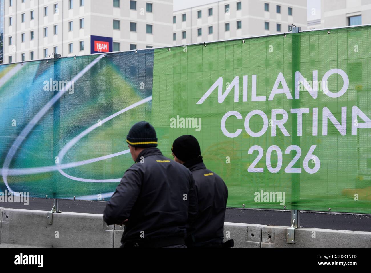 Financial guards walk outside the Olympic Village, in Milan, Italy ...