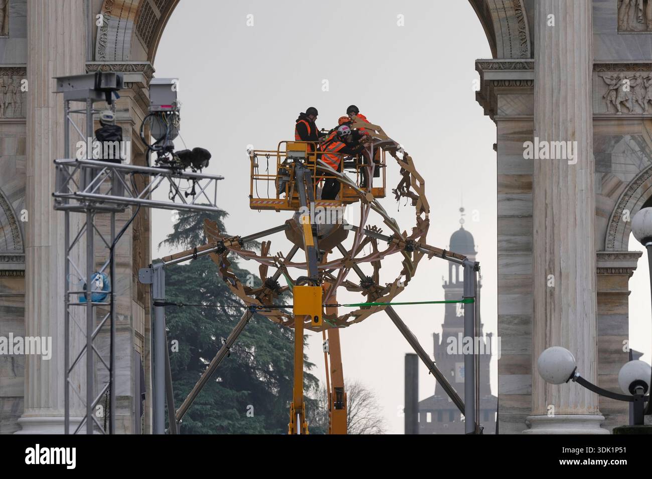 Workers set the Olympics cauldron at the Peace arch in Milan, Italy ...