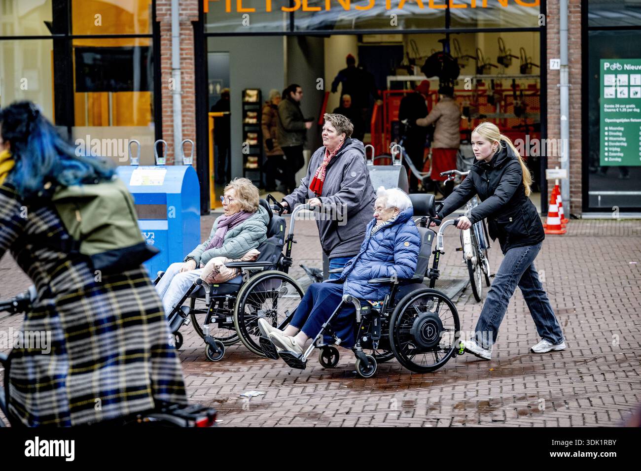 GOUDA - Walking on the street with a person in a wheelchair ROBIN ...