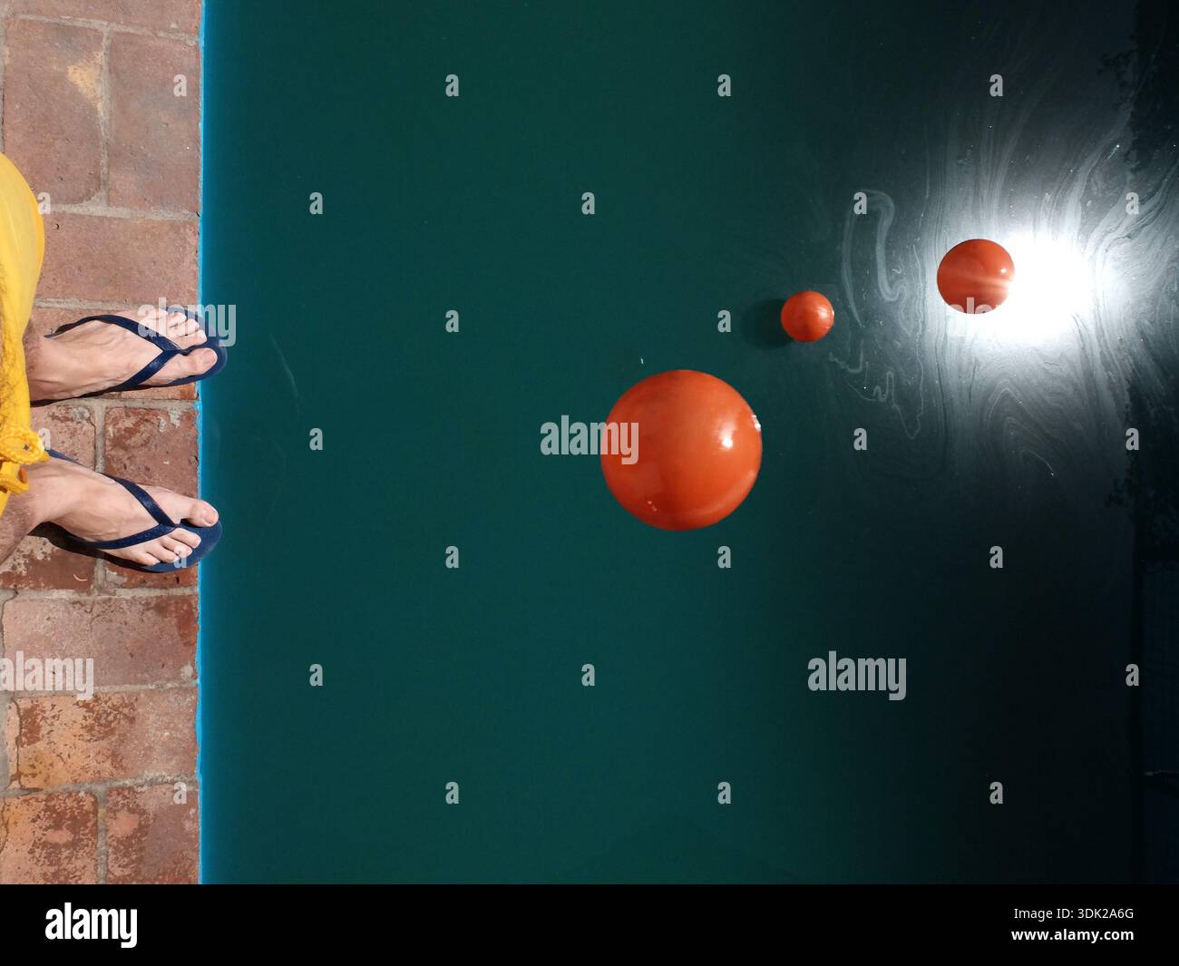 Red balls falling into the pool water Stock Photo - Alamy