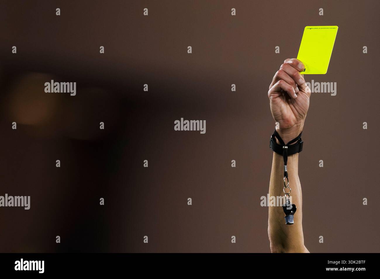 A yellow card is shown by referee Jose Maria Sanchez Martinez during ...