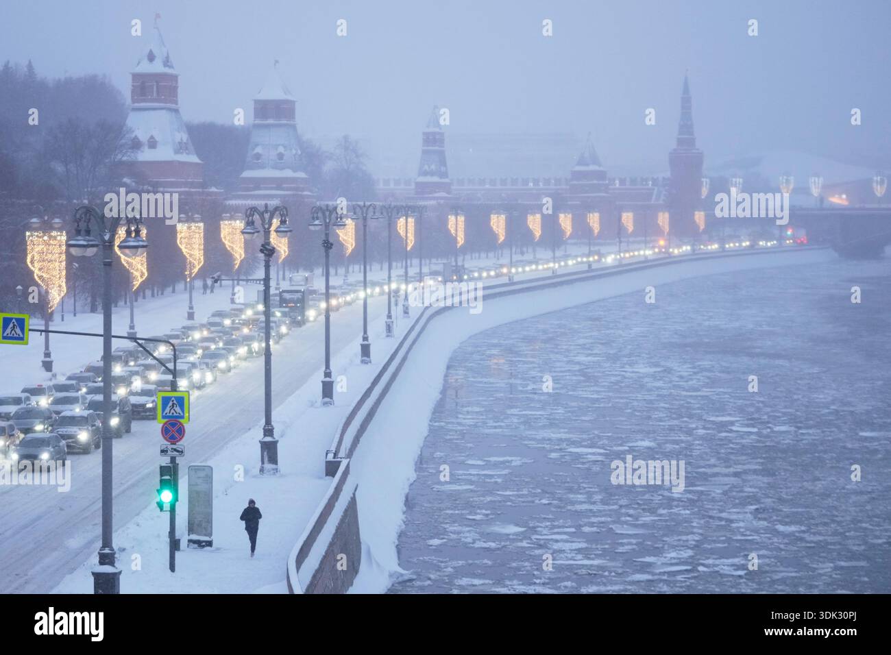 A man jogs along the Kremlin Wall and the ice-covered Moskva River ...