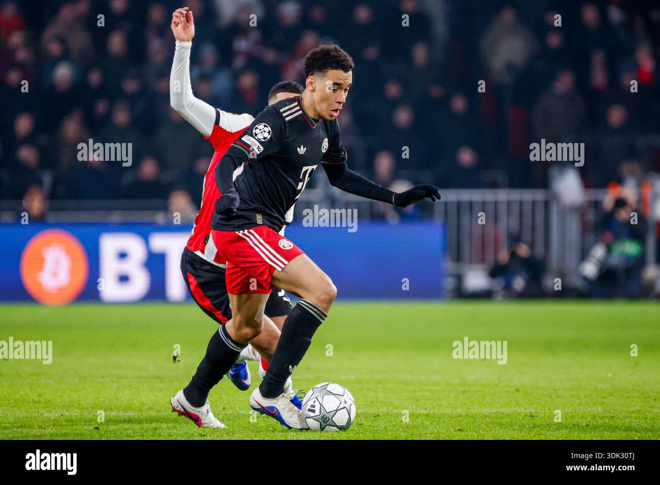 Jamal Musiala of FC Bayern Munchen dribbles with the ball under ...